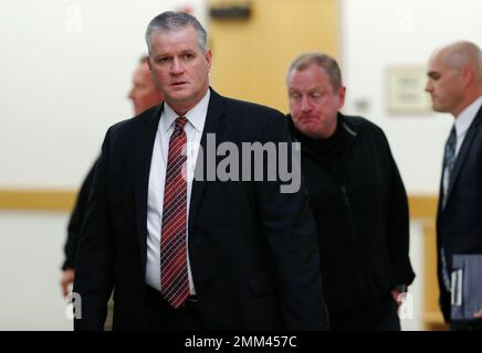 Michael J. Rourke, District Attorney for Weld County, listens to the ...