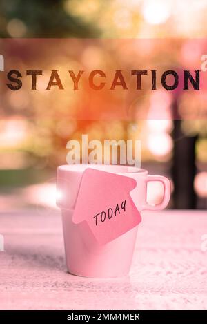 Hand writing sign Staycation. Business concept a vacation spent at one ...
