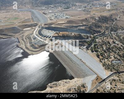 An aerial view of the labyrinth weir, main dam and both spillways at ...