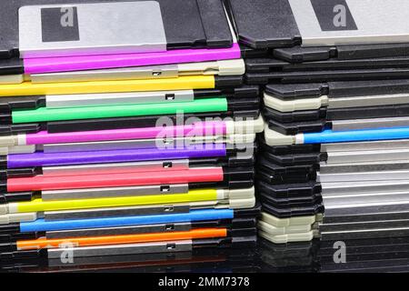 Pile of vintage floppy disks in multi-colored theme technology ...