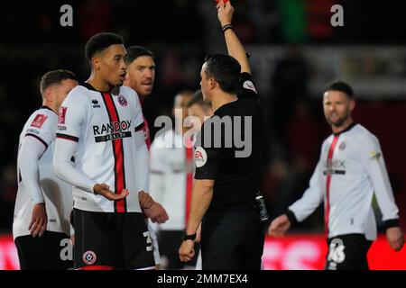 Referee Dean Whitestone shows a red card to Swansea City's Harry ...