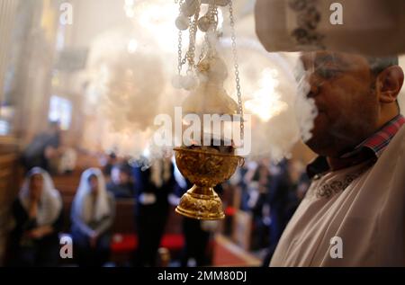 A priest spreads incense during in activities to commemorate Palm ...