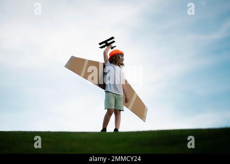 Happy kid playing in pilot helmet pretend to be aviator. Travel ...