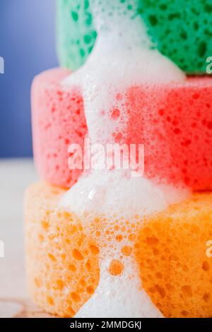 colorful sponges with soap bubbles for washing Stock Photo - Alamy