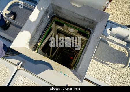 A vertical launching system cell is open on the Arleigh Burke-class ...