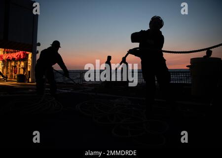 Crew members aboard USCGC Bear (WMEC 901) tend hawser line for the tow ...