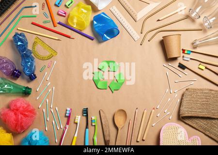Recycling symbol and household goods on light blue background, flat lay ...