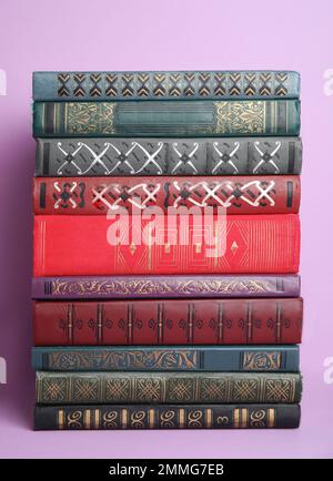 Collection of old books on violet background Stock Photo - Alamy