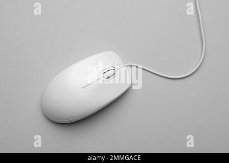 Wired computer mouse on light grey marble background, top view. Space ...