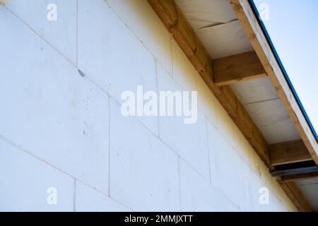 The wall of the house is insulated with white polystyrene foam ...