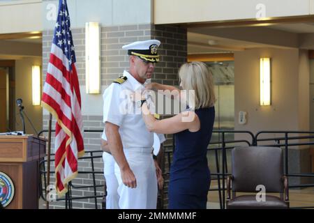 Leah Hawker, the wife of Capt. Jeremy J. Hawker, pins on his command ...