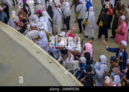 Muslim pilgrims cast stones at three huge stone pillars in the symbolic ...