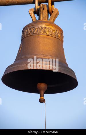 Large Church bell hanging outside. Close-up view of metal orthodox ...