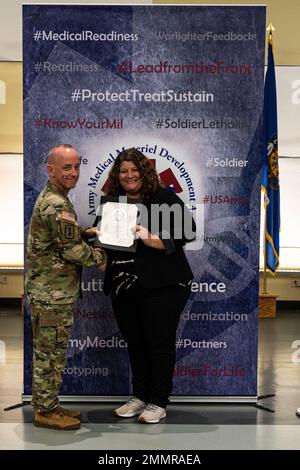Col. Andy Nuce presents Erica Smith a 20 year Service Award certificate ...