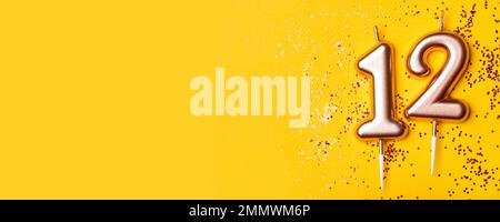 Number 12 gold birthday celebration balloon on a confetti glitter ...