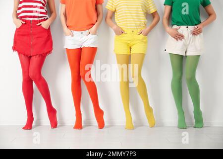 Women wearing bright tights near white wall, closeup Stock Photo - Alamy