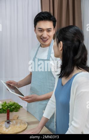 Happy young families making refreshments tablets Stock Photo - Alamy