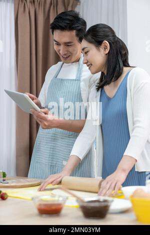 Happy young families making refreshments tablets Stock Photo - Alamy
