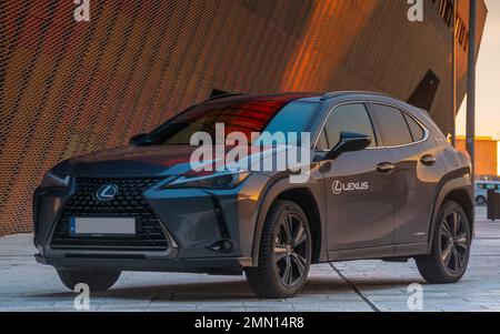Lexus UX hybrid SUV against the background of a modern building in the ...