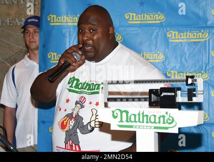Competitive eater Eric "Badlands" Booker speaks at a weigh-in before ...
