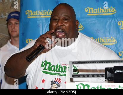 Competitive eater Eric "Badlands" Booker speaks at a weigh-in before ...