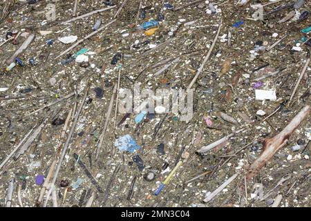 A giant floating rubbish heap floating in the river, plastic pollution ...
