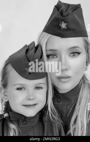 Russian female soldier poses for a portrait with her daughter Stock ...