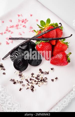 strawberries, liquorice, vanilla pods and flake chocolate Stock Photo ...