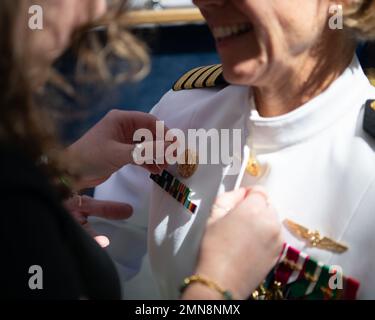 Capt. Kimberly P. Toone is pinned by her husband and daughter as she ...