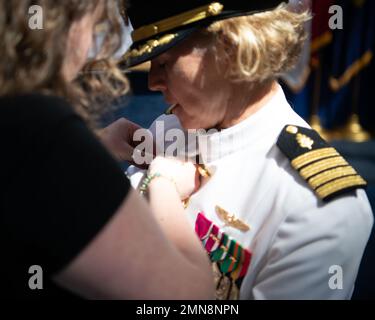 Capt. Kimberly P. Toone is pinned by her husband and daughter as she ...