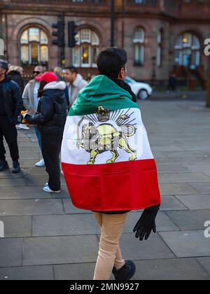 Iranian men wave Iran flags as one of them holds-up a portrait of ...