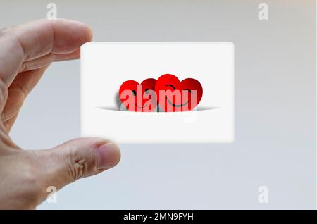 Hand holding card with happy hearts illustration Stock Photo - Alamy