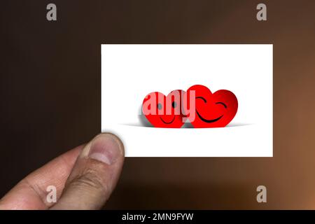 Hand holding card with happy hearts illustration Stock Photo - Alamy
