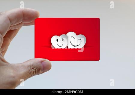 Hand holding card with happy hearts illustration Stock Photo - Alamy