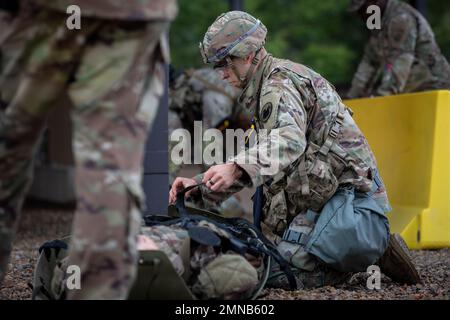 Army Reserve Spc. Brady A. Benedict (center), a military policeman ...