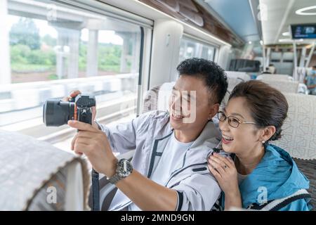 Happy older couples take pictures with a camera on the subway Stock ...