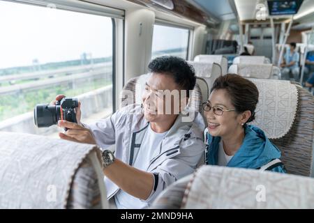 Happy older couples take pictures with a camera on the subway Stock ...