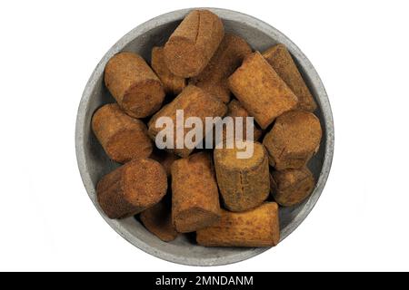 Dutch cinnamon candy sticks in a concrete bowl isolated on white ...