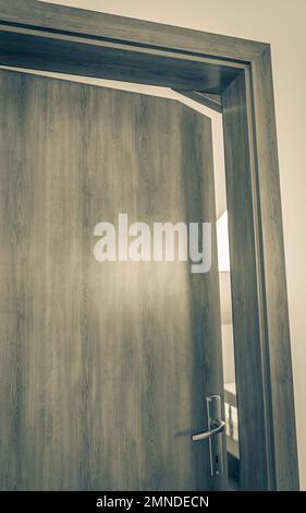 Open wooden door small slit to a white bedroom Stock Photo - Alamy