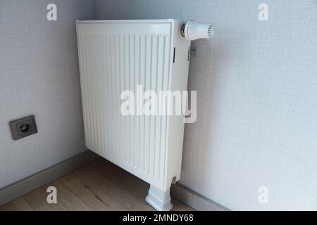 heating radiator under window in the room Stock Photo - Alamy