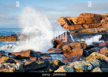 Water dashing against rocks on the rocky coast on Isle of Skye ...