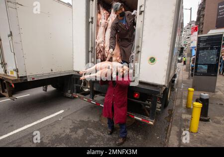 Delivery of pig carcasses to an eatery in Chinatown, New York city, USA ...