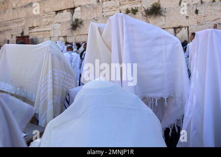 Cohanim or Jewish priests cover their heads with their prayer shawls ...