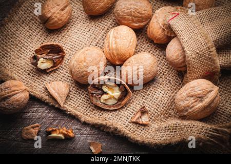 handful of nuts on a sheet of jute with broken shell Stock Photo - Alamy