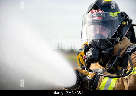 A firefighter from the 422d Fire Emergency Services extinguishes an ...