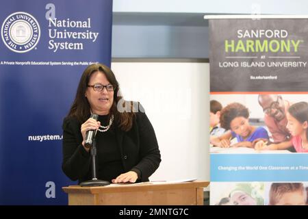 Dr. Kimberly Cline, president of Long Island University, presents philanthropist T. Denny ...