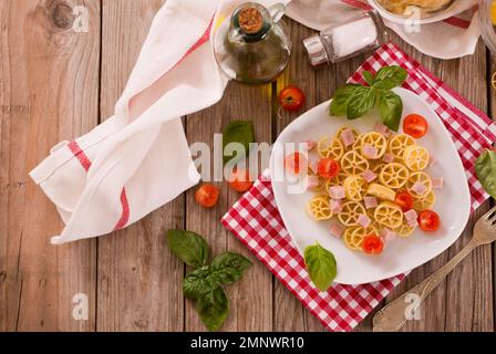 Ruote pasta with tomato and ham Stock Photo - Alamy