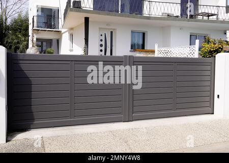 sliding portal large metal gate high grey fence on suburb street house ...