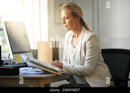 Success is dependent on effort. a businesswoman working on paperwork in ...