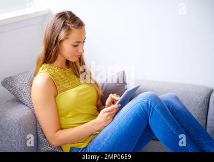 Catching up on some social media. a young woman using her laptop on the ...